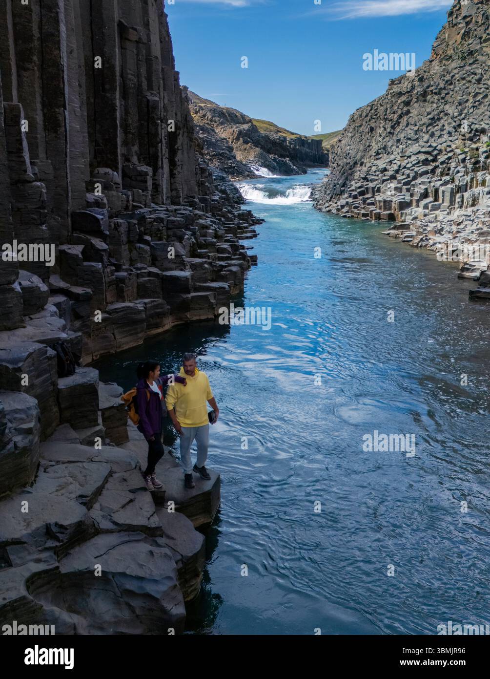 Visitors marvel at the stunning basalt columns and clear waters of ...