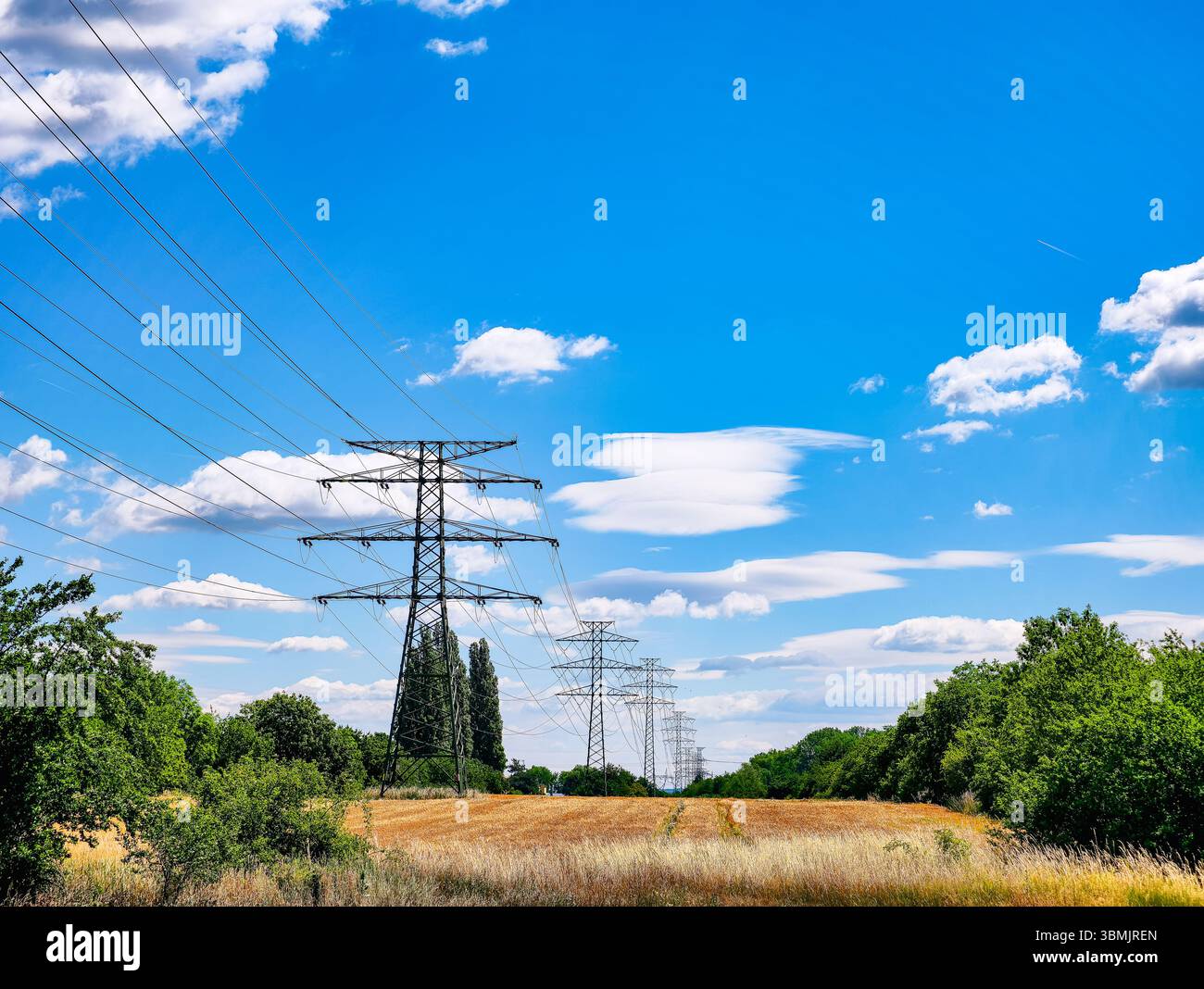 Expansive Rural Landscape Featuring Power Lines Against a Clear Blue ...