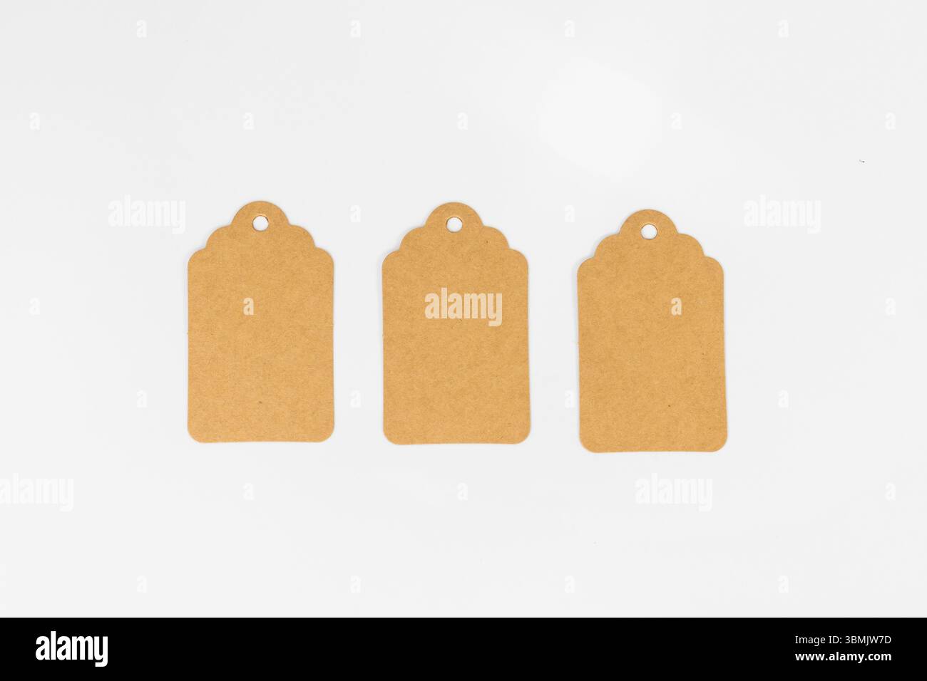 Three Brown Kraft Paper Tags on White Background Stock Photo - Alamy