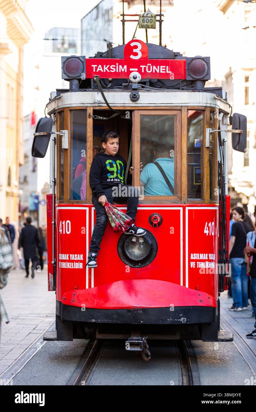 Istanbul, Turkiye - MAY 12, 2025: The red nostalgic tram and people ...