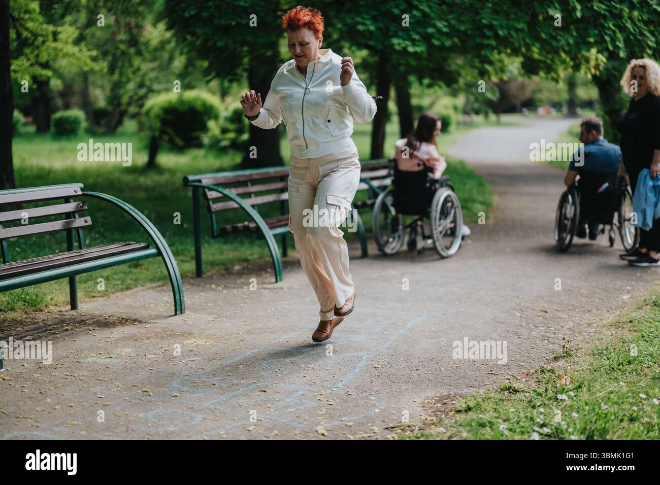 Dynamic scene in a park with individuals engaging in outdoor activities ...