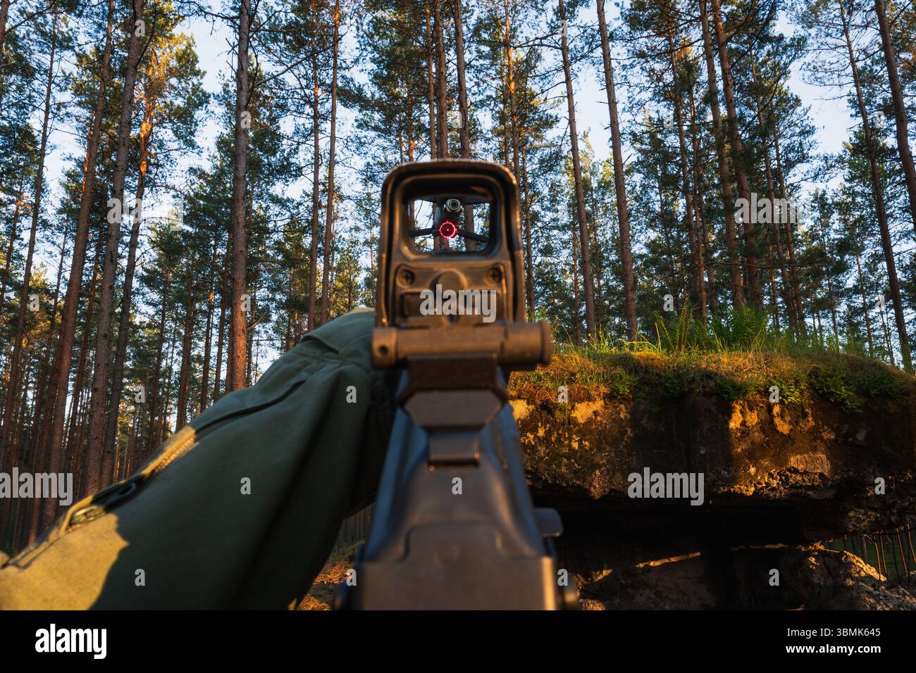 First-Person View (POV): A soldier aiming an assault rifle with a red ...