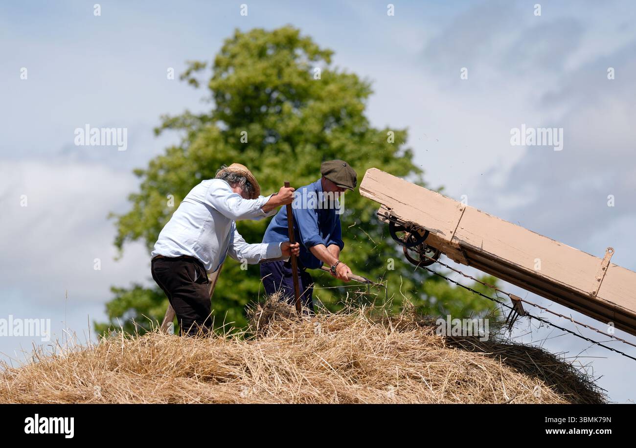 James Holland (right) helps build a Hayrick using traditional ...