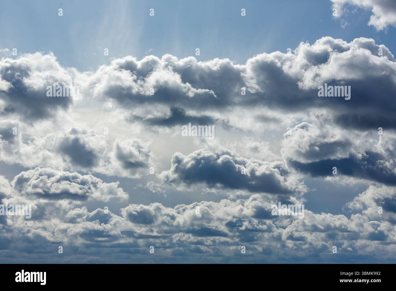 A sky filled with dark and light clouds, creating a dramatic and ...