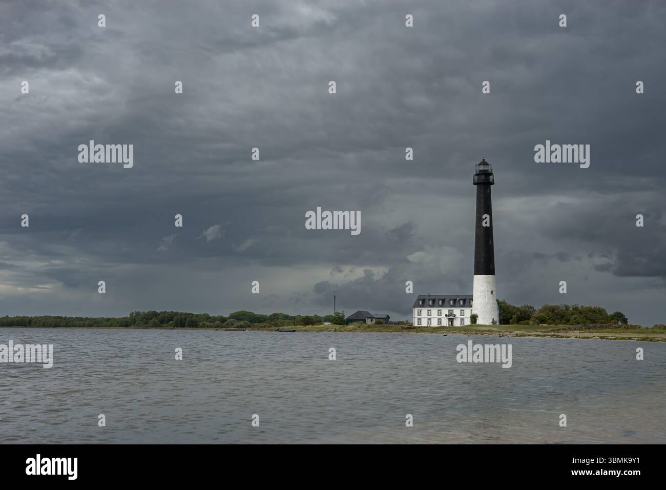 The iconic black-and-white lighthouse of Sõrve on Saaremaa Island under ...