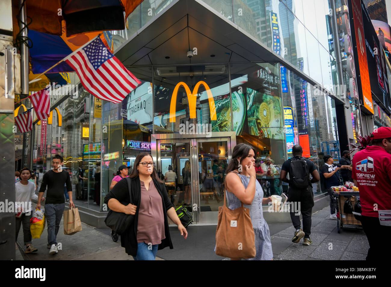 Crowds pass a McDonald's restaurant in Times Square in New York on ...
