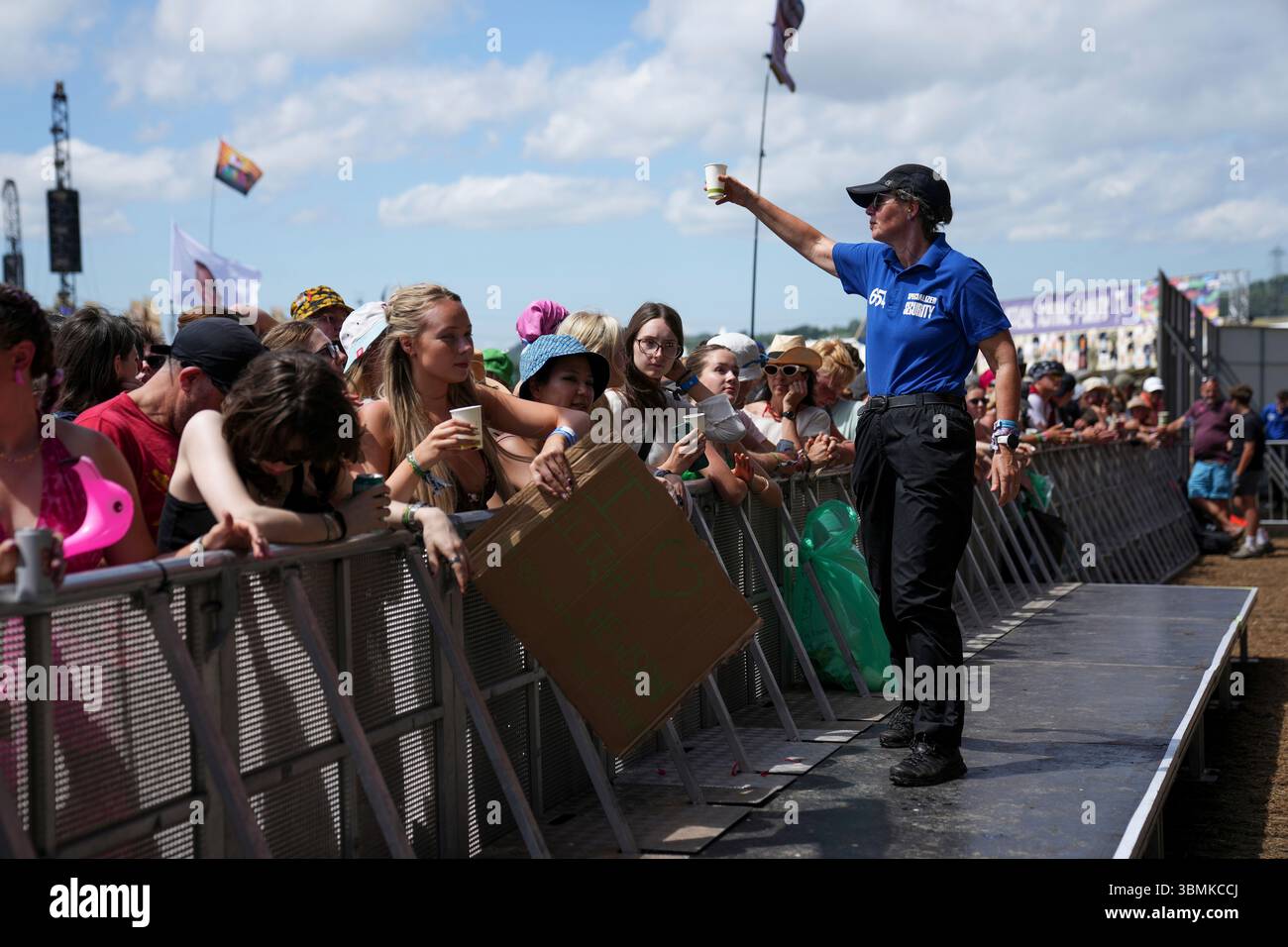 A festival worker hands out water to festivalgoers during the ...