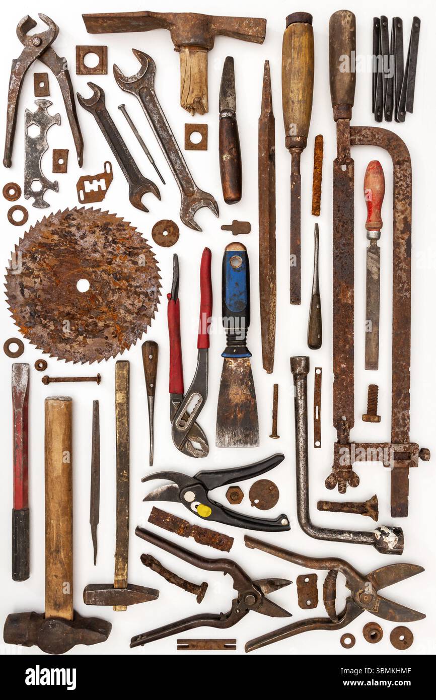 Flat lay of old hand tools on white background. Large collection of various rusty tools and bits ...