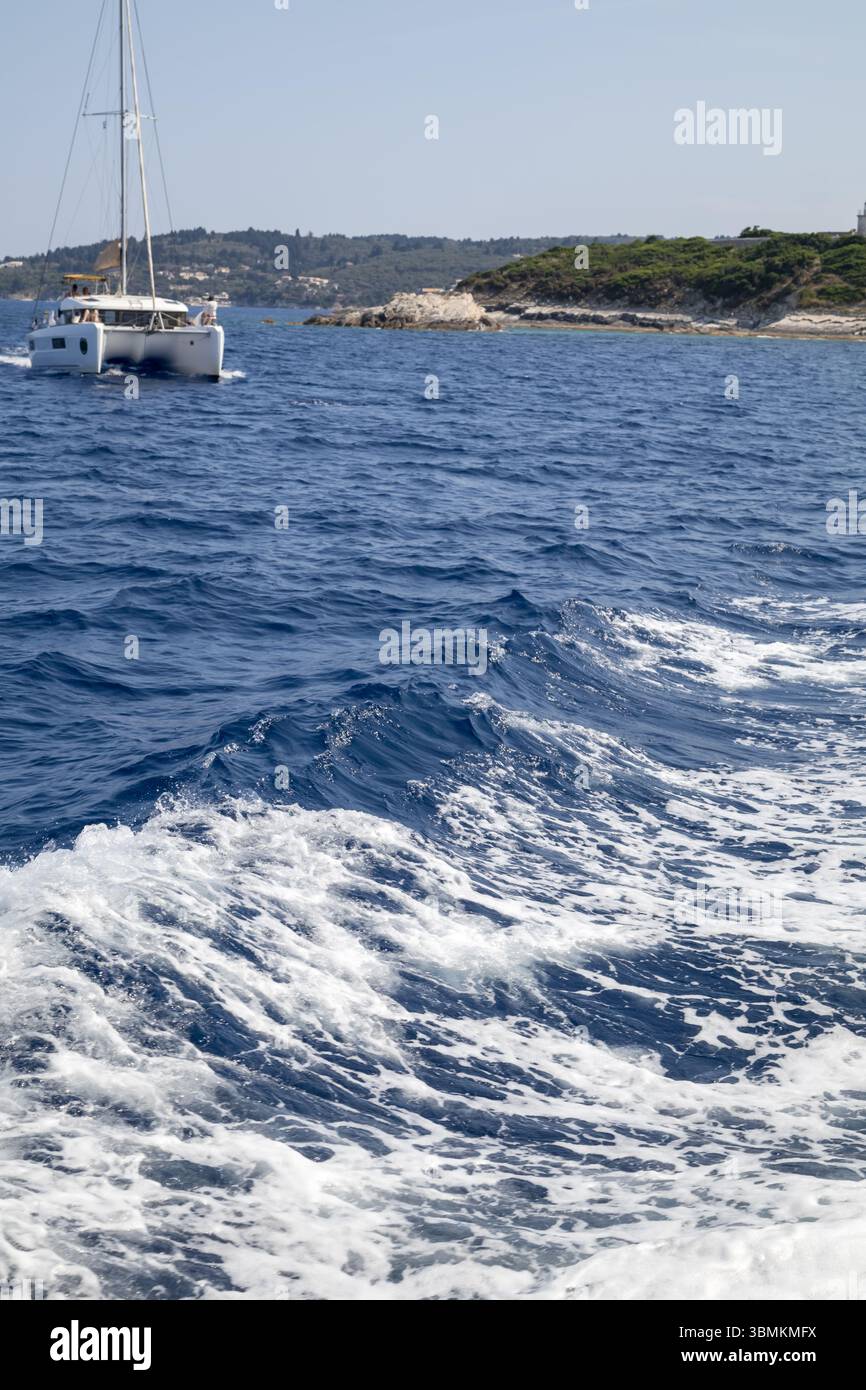 Boat's Wake on Blue Ocean Water with Catamaran in Background Stock ...