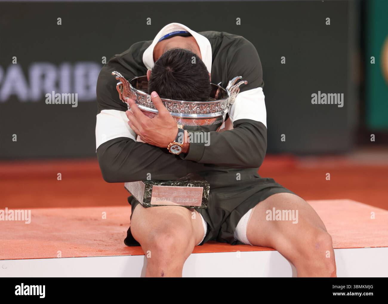 French Open 2025 winner Carlos Alcaraz putting his head into the trophy ...