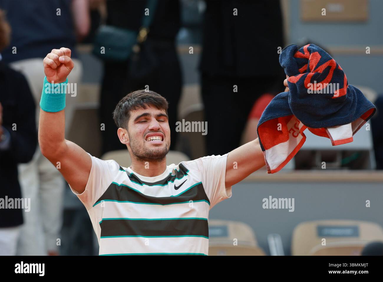 Spanish tennis player Carlos Alcaraz raising his arms after winning the ...