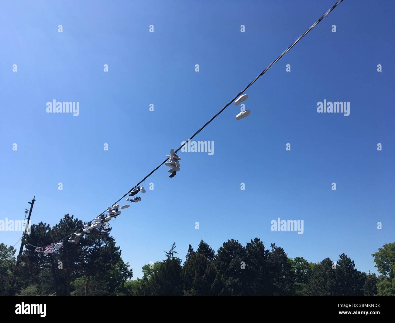 shoes dangle from a cable at Letná Park above the Vltava, a quirky ...