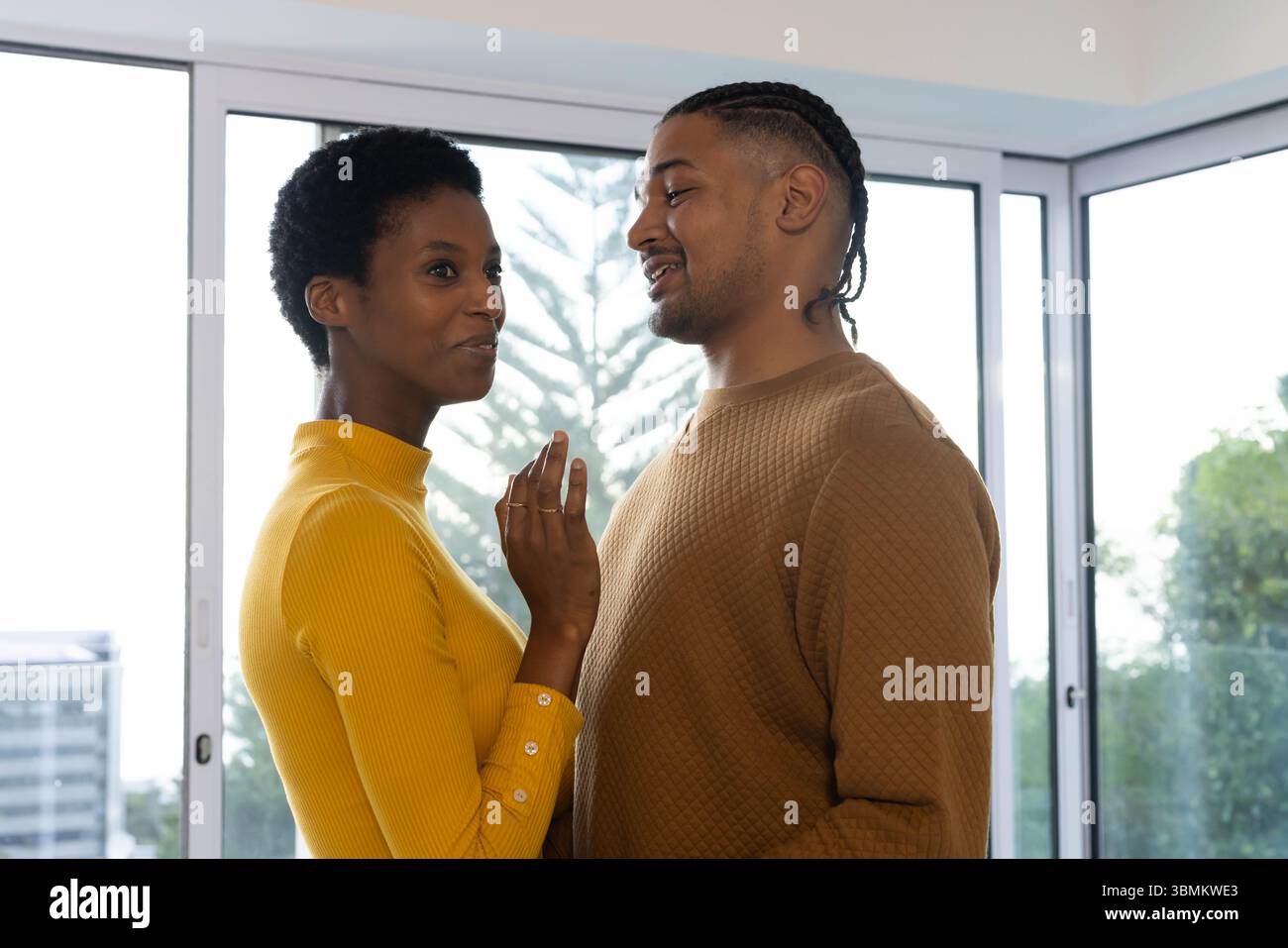 Standing close Diverse couple showing engagement ring by floor-to ...