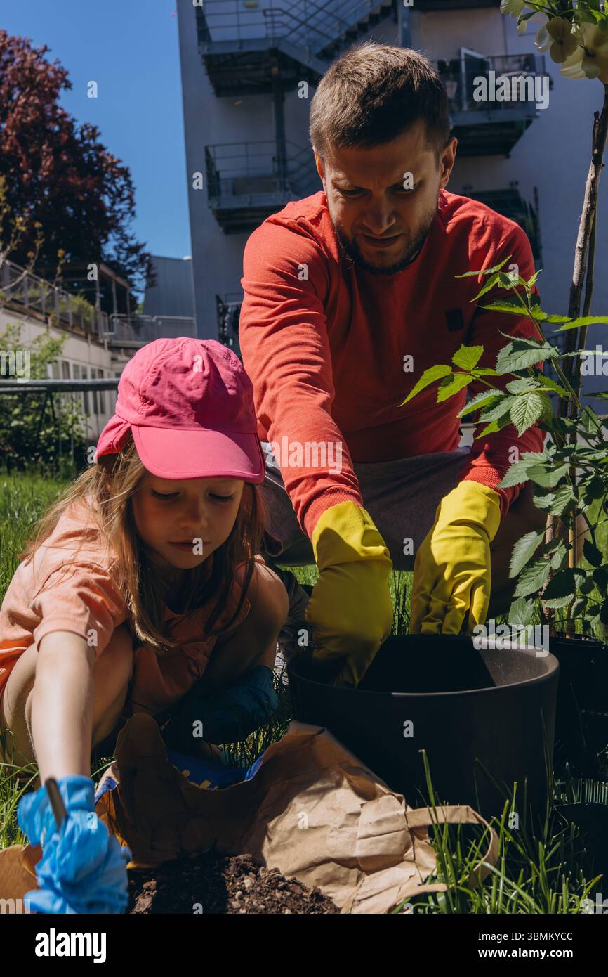 Parents children work together planting hi-res stock photography and ...