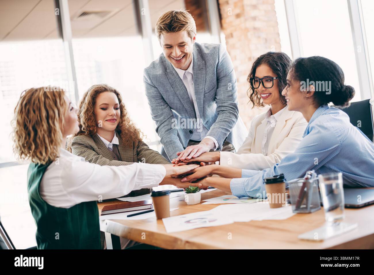 Diverse coworkers engage in a team-building activity in modern office ...