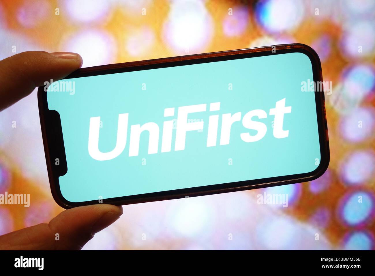 In this photo illustration, the UniFirst company logo is seen displayed ...