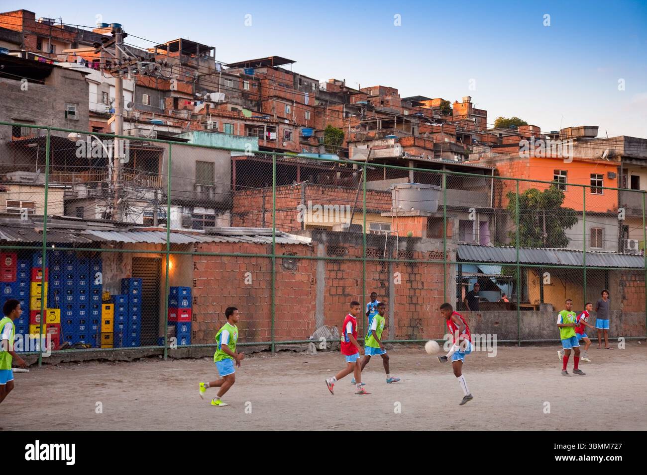 Brazil, Rio de Janeiro, children on a soccer field in one of the many ...