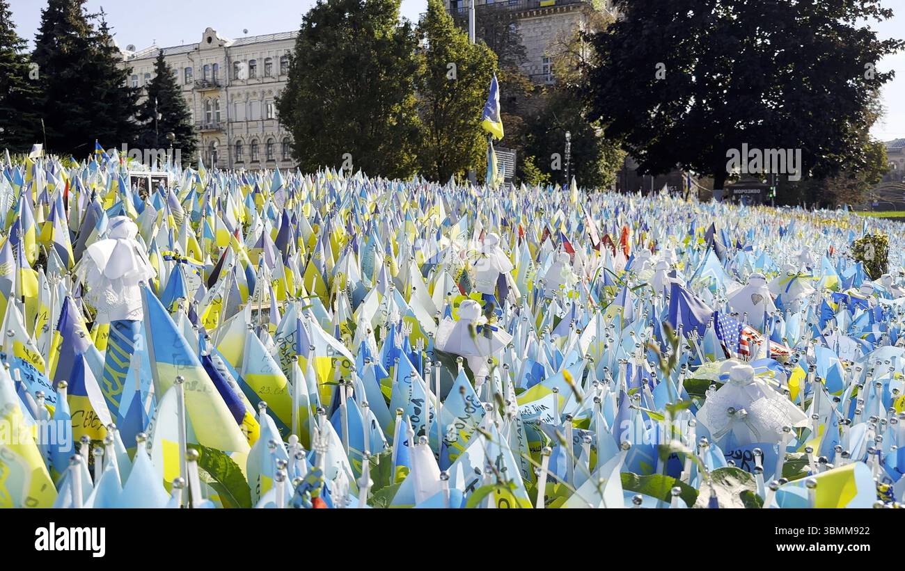 Many small blue-yellow flags with names of the dead war against russia ...
