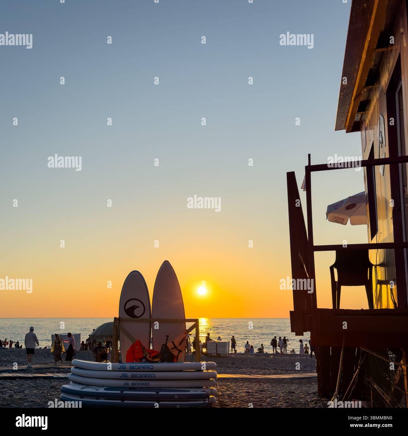 Stacked SUP boards and rescue station by the Black Sea at sunset ...