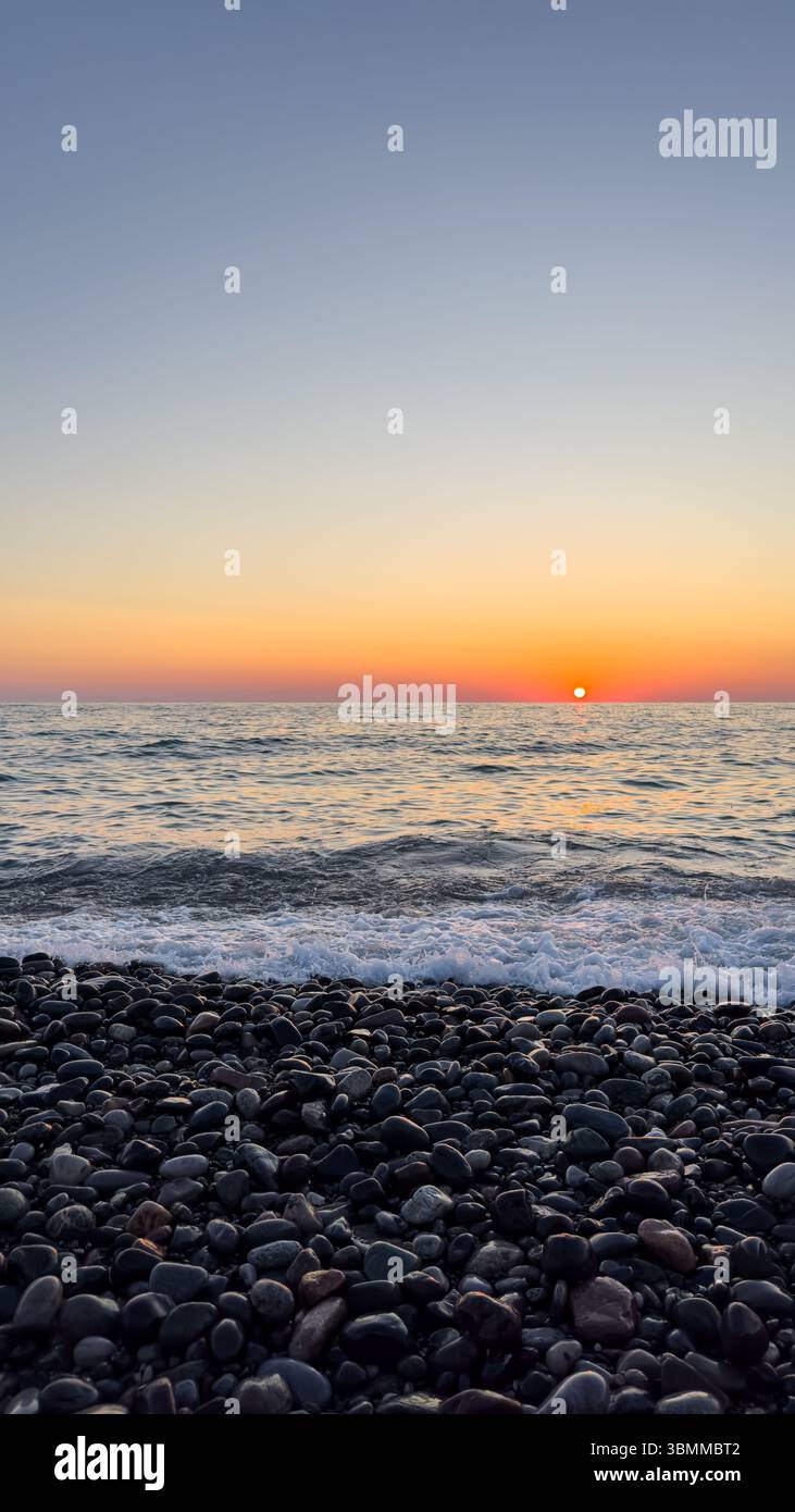 Pebble beach and waves at sunset on the Black Sea, Batumi, Georgia ...