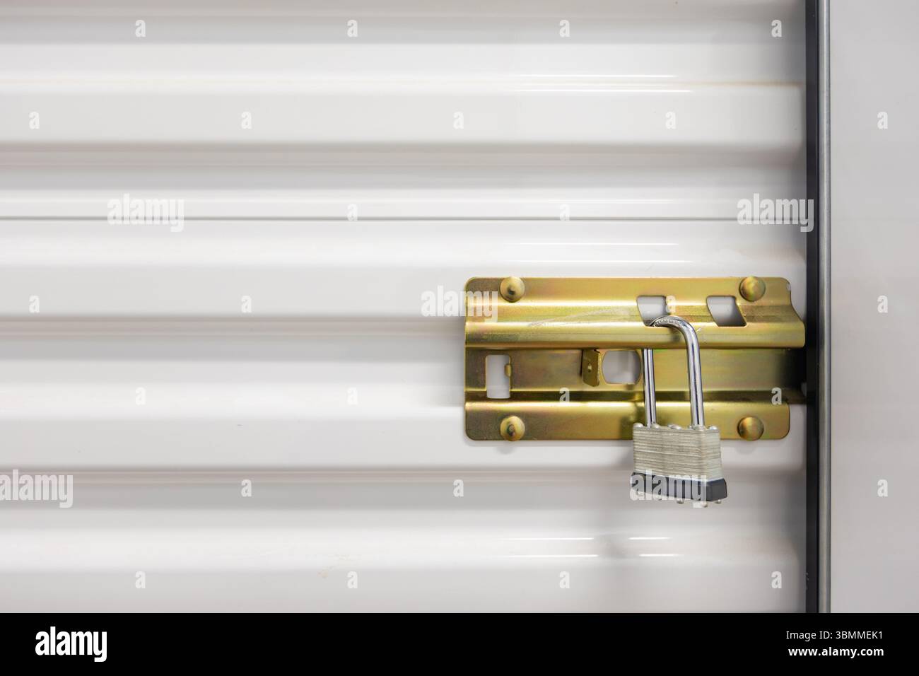 Key lock securing door on self storage unit Stock Photo - Alamy