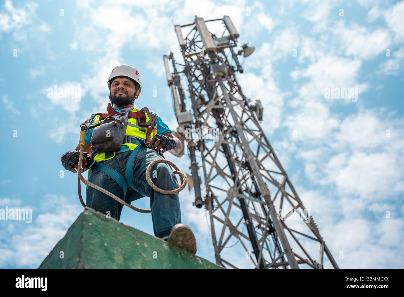 Technicians climbing network tower with safety gears, fixing mobile ...