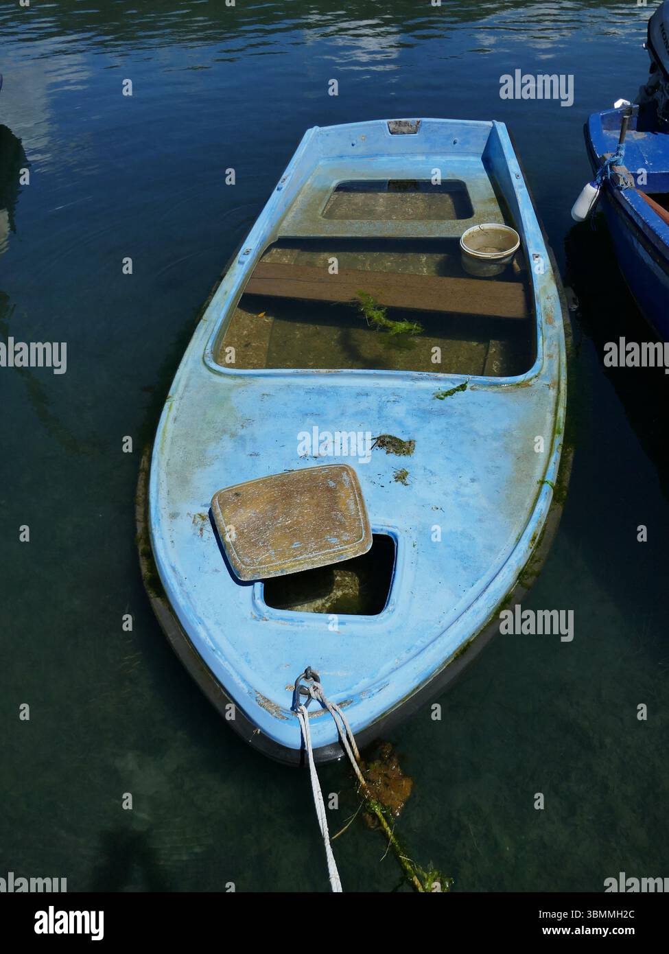 Waterlogged boat sunken in ocean and full of water vertical photo Stock ...