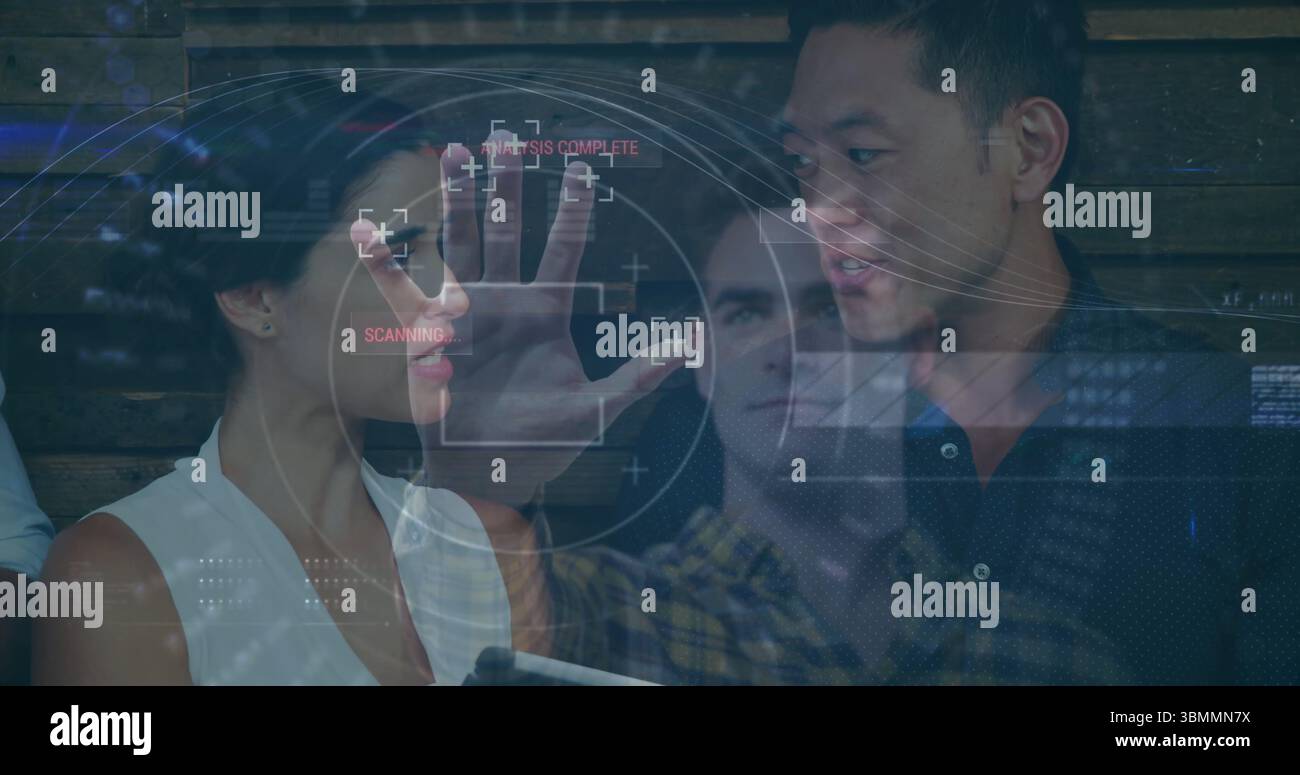 Interacting trio of colleagues performing biometric scan on holographic ...