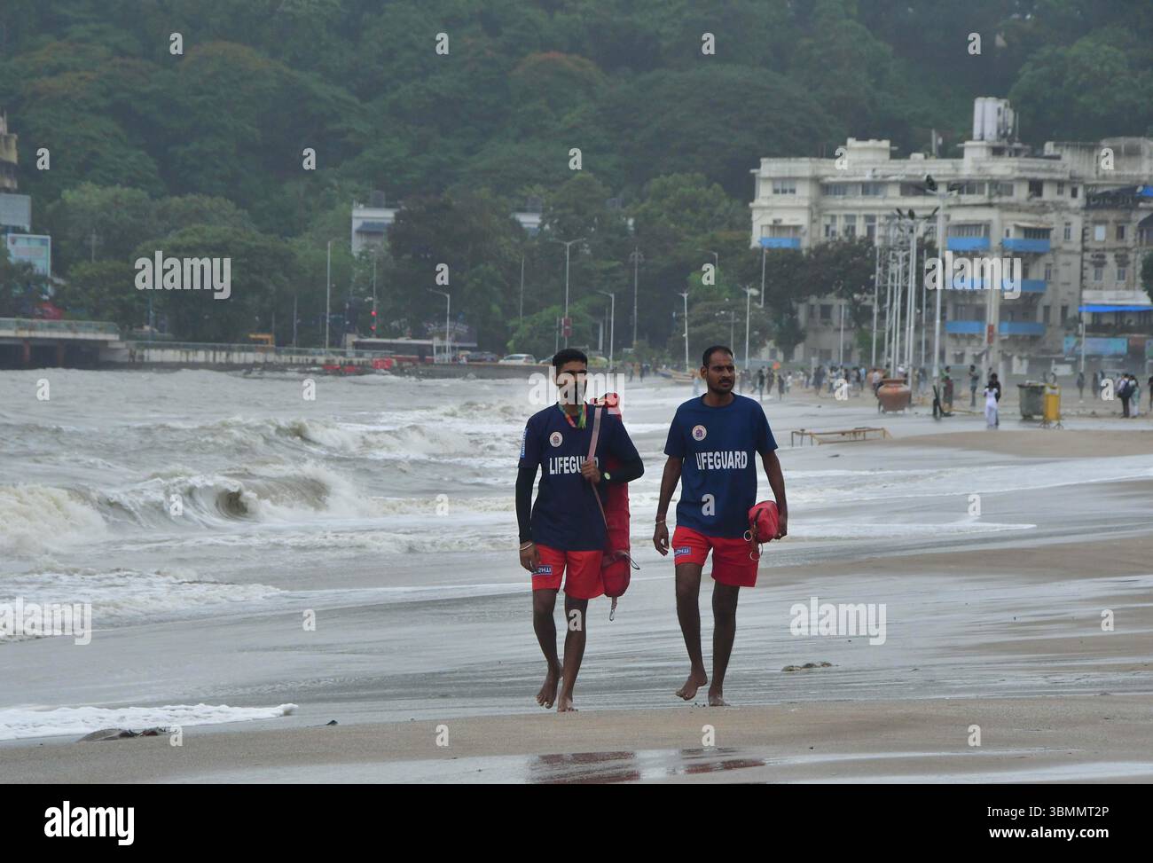 MUMBAI, INDIA - JUNE 27: A lifeguard patrols during high tide at ...
