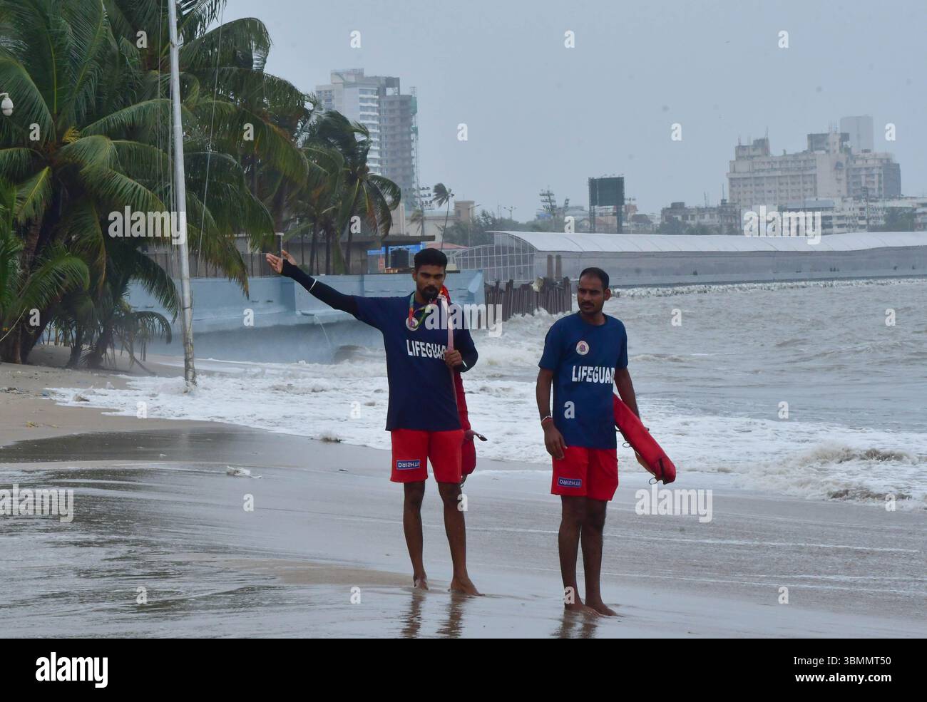 MUMBAI, INDIA - JUNE 27: A lifeguard patrols during high tide at ...