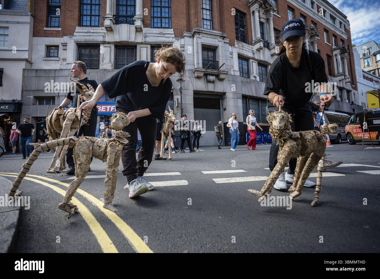 LONDON, UK – 27 June 2025: Performers manoeuvre life-size cardboard ...