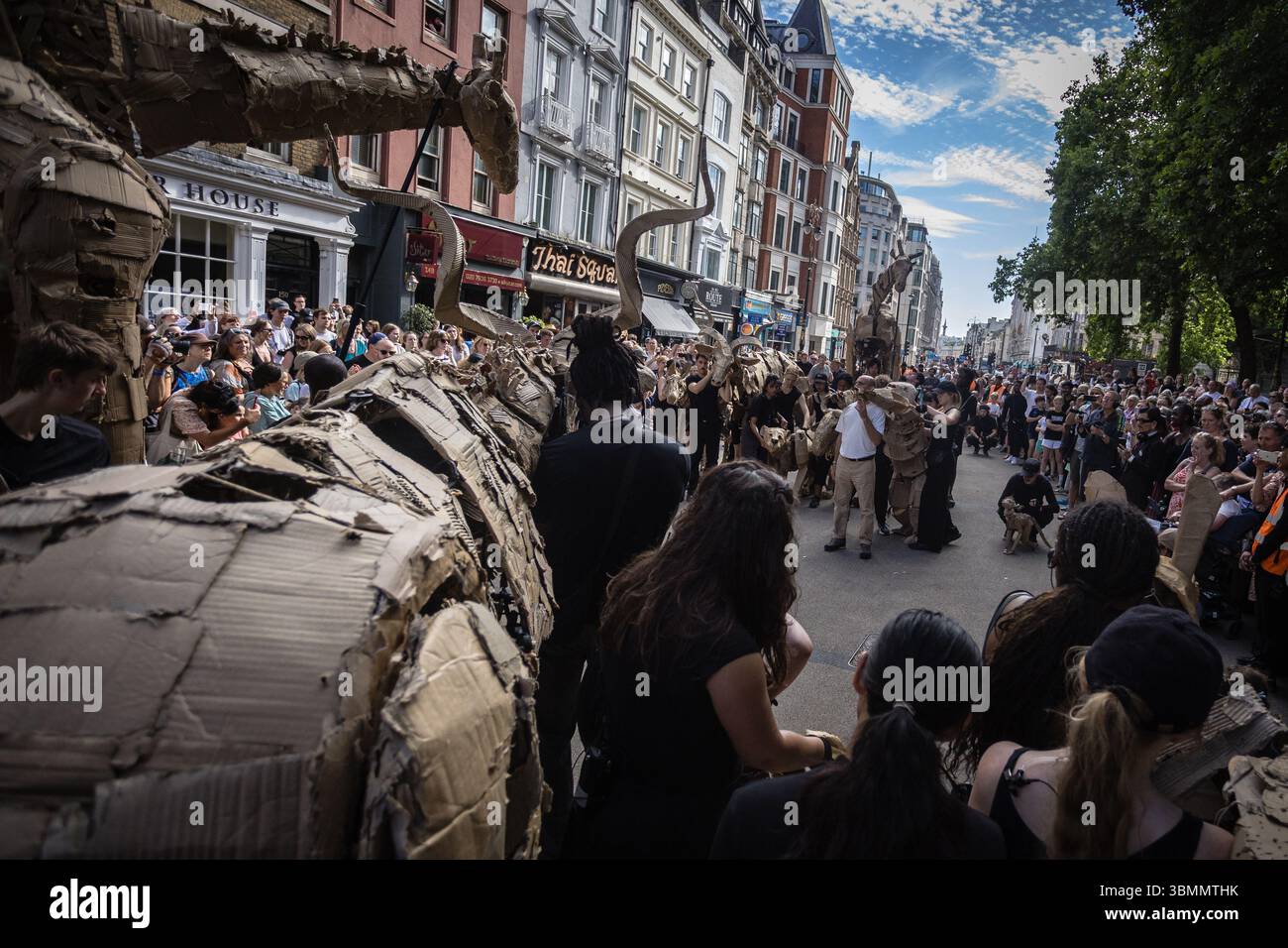 LONDON, UK – 27 June 2025: Performers manoeuvre life-size cardboard ...