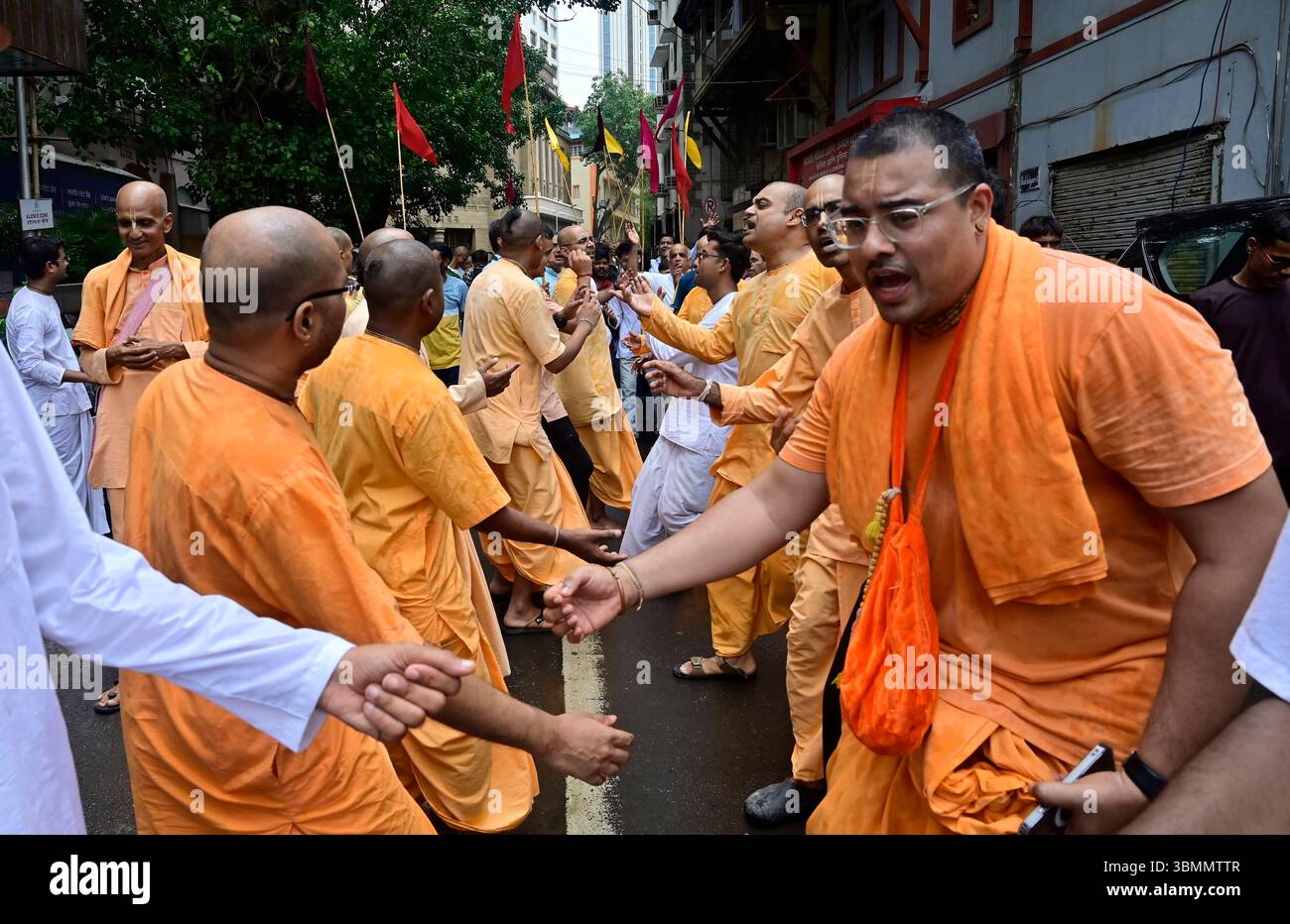 MUMBAI, INDIA - JUNE 27: Devotees seen dancing and pulling the chariot ...