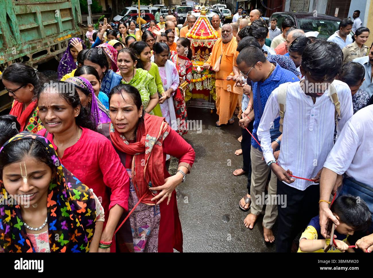 MUMBAI, INDIA - JUNE 27: Devotees seen dancing and pulling the chariot ...