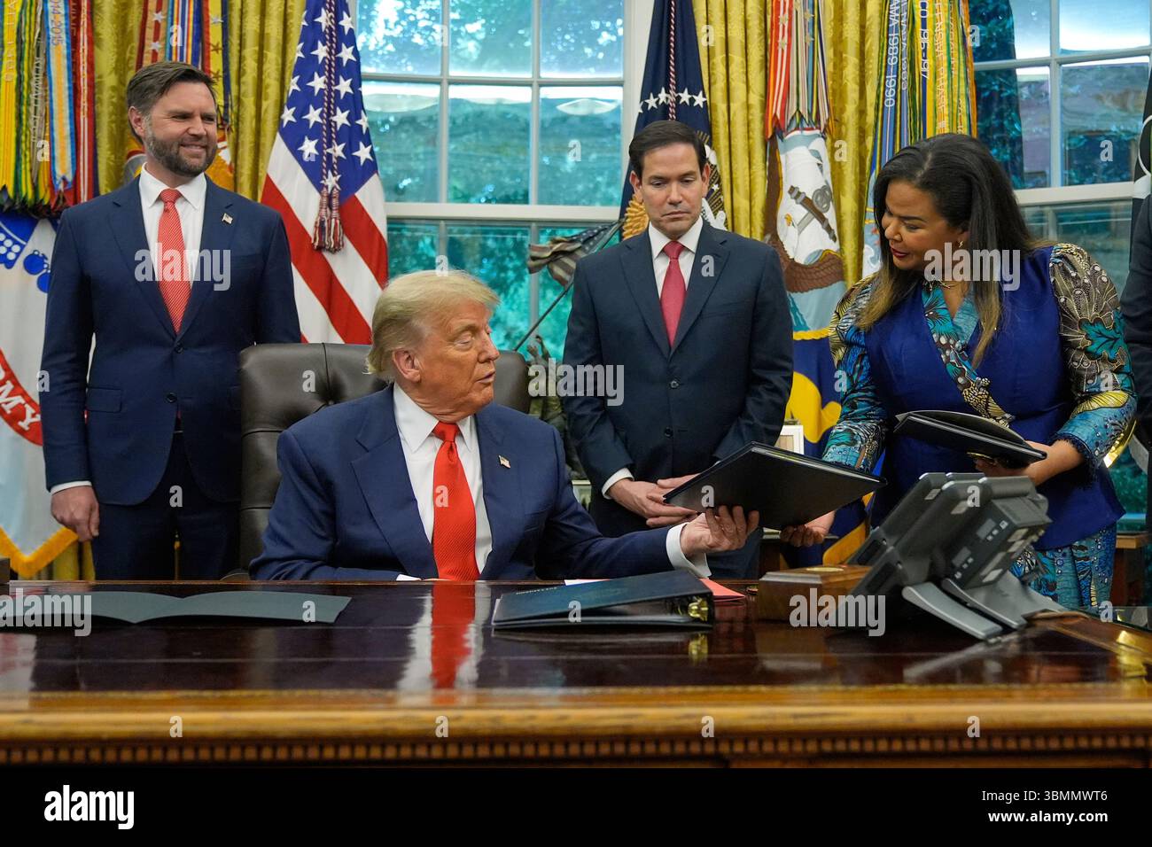 President Donald Trump hands a signed document to Congo's Foreign ...
