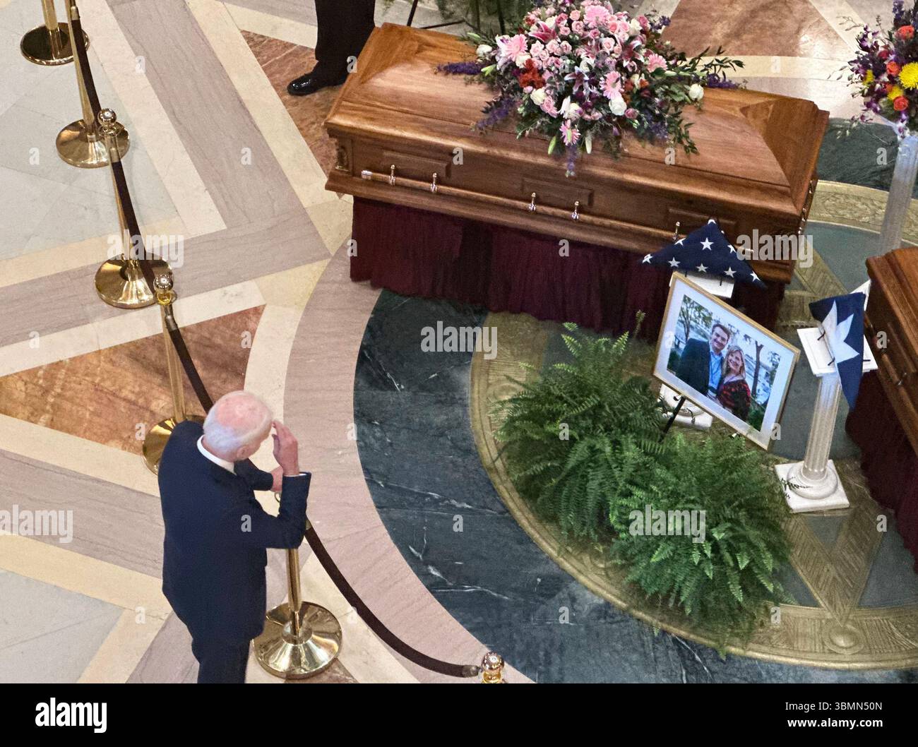 Former President Joe Biden makes a sign of the cross while paying his ...