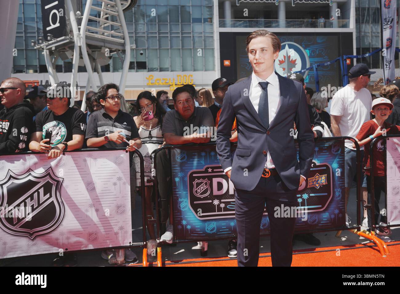 Victor Eklund poses on the red carpet before the NHL hockey draft ...