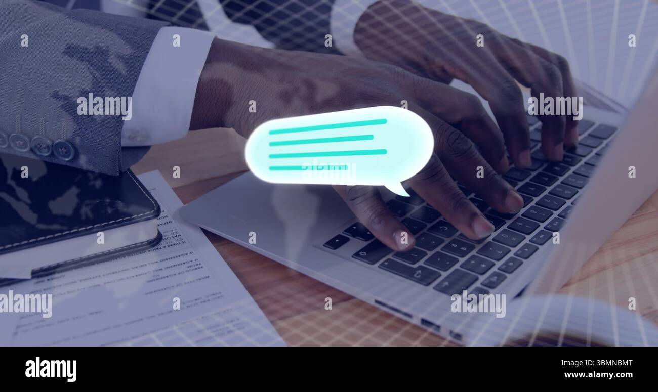 Typing hands pressing laptop keys at corporate desk, with smartphone notebook and speech bubble ...