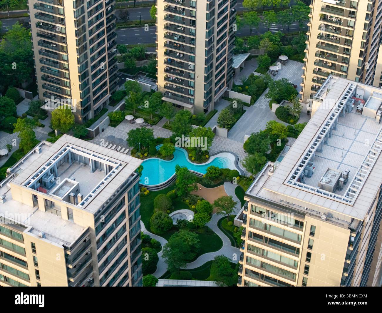 Aerial view of modern residential area featuring greenery, water ...