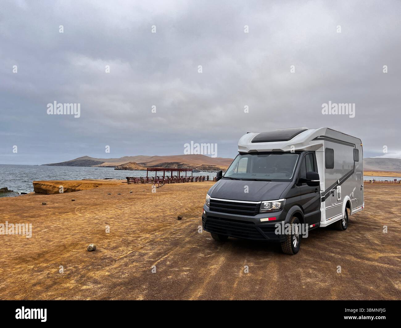 Modern RV motorhome while standing desert landscape next to red sand ...