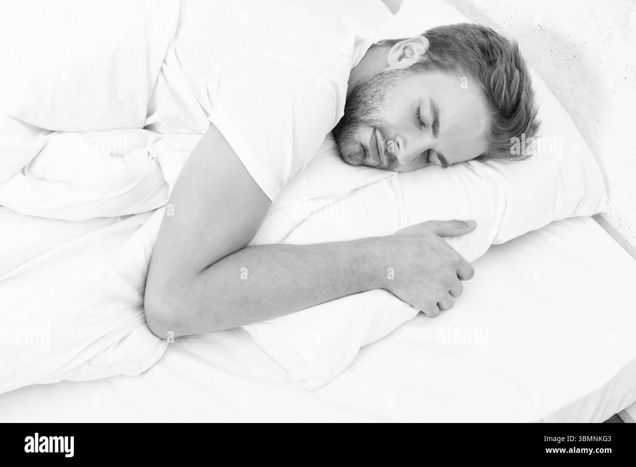 Man sleeping at night. Sleepy man lying on bed sleeping at white ...