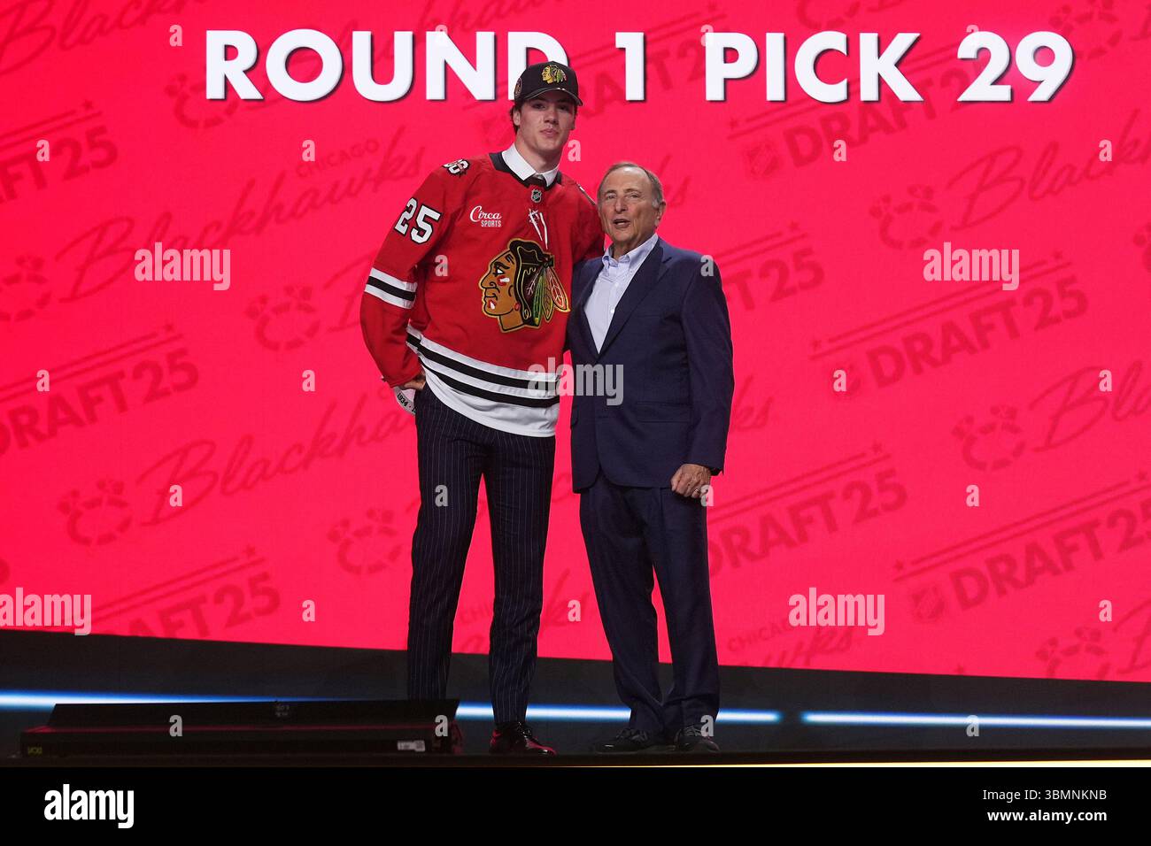 Mason West, left, stands with NHL commissioner Gary Bettman after being ...