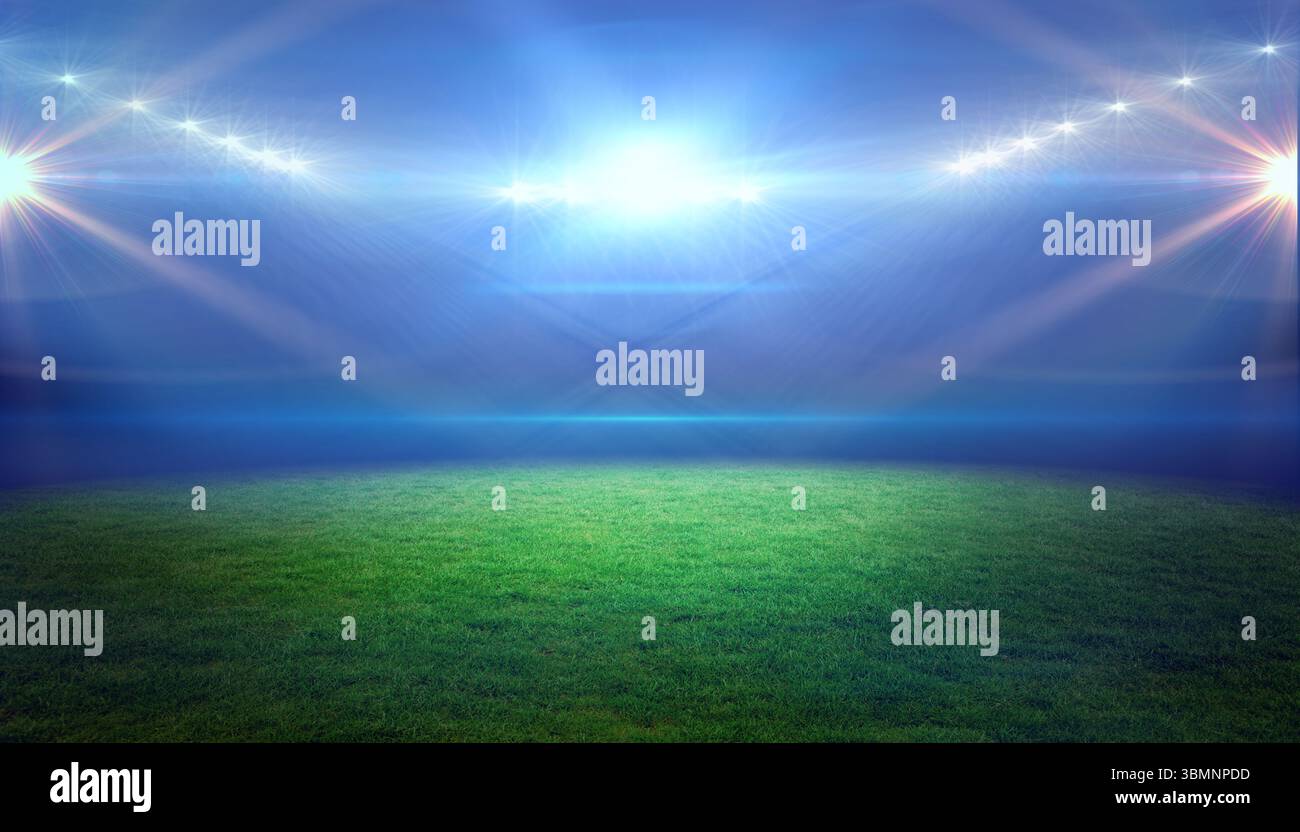 Empty grass pitch is being floodlit at night, casting blue-white beams ...