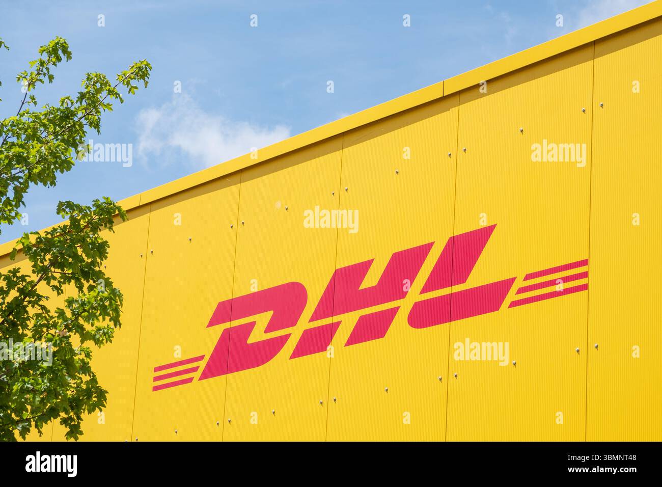 The striking DHL logo on the distribution centre in Bornheim, an ...