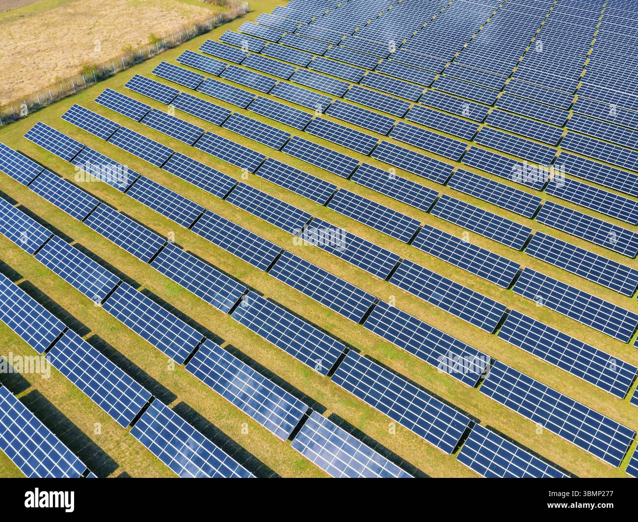 Aerial view of a solar park with many photovoltaic modules for ...