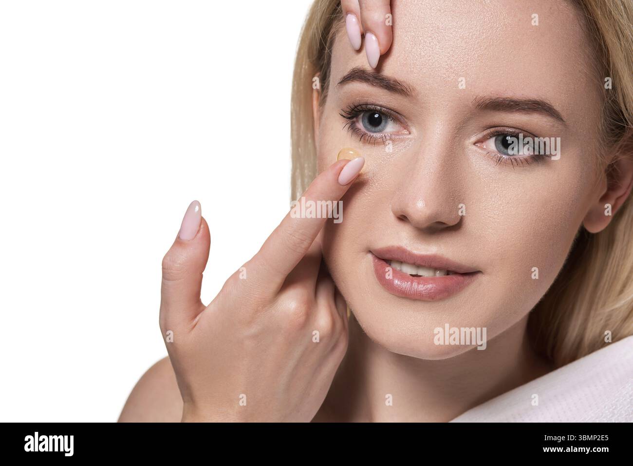 Young woman holding contact lens on index finger with copy space. Close ...