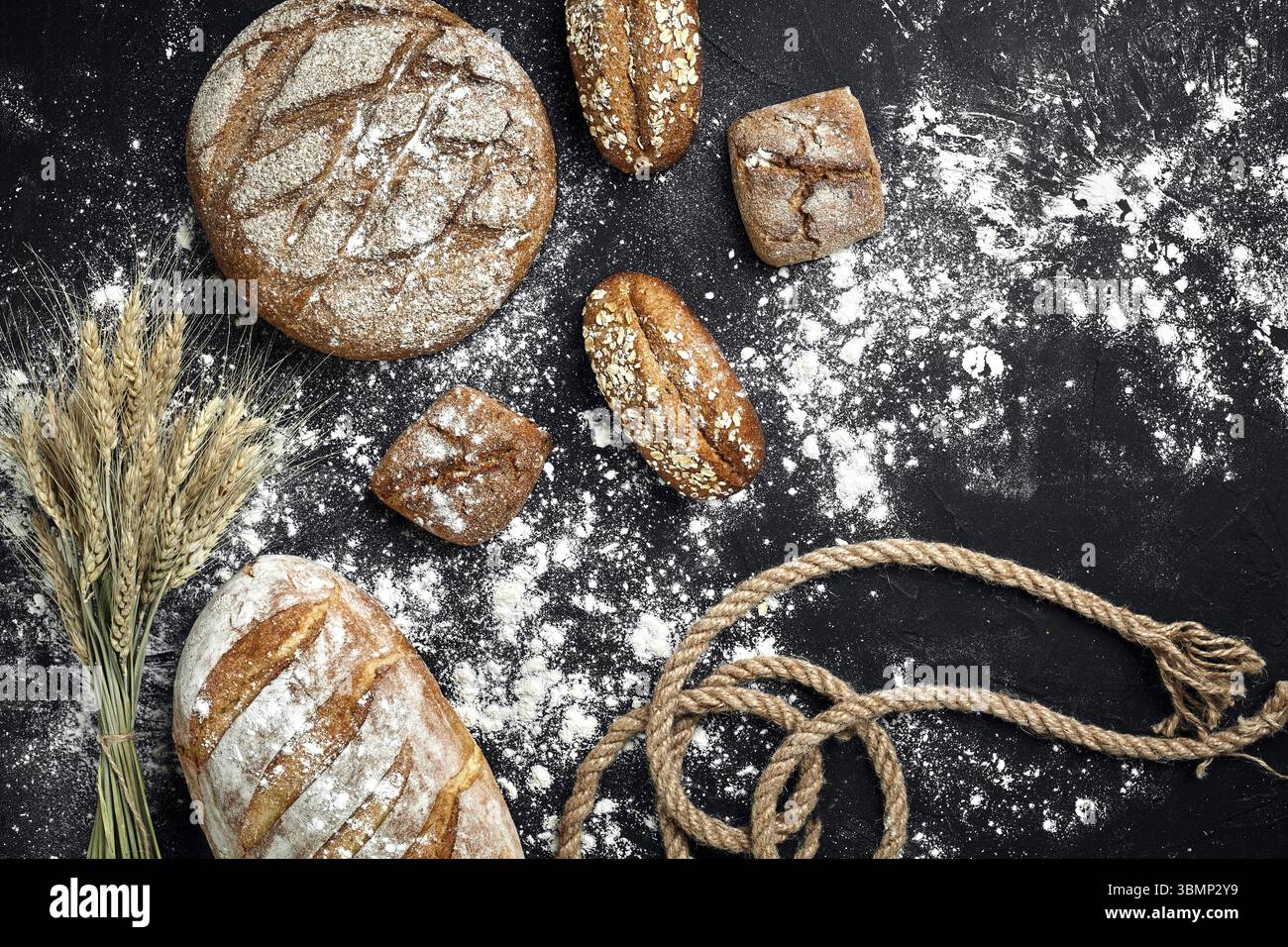Homemade rye bread sprinkled with flour and various grains and seeds on ...