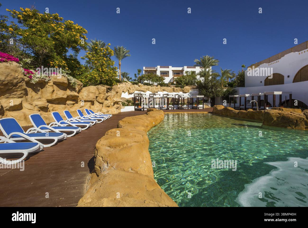 Long exposure shot of a swimming pool and luxury buildings behind it ...