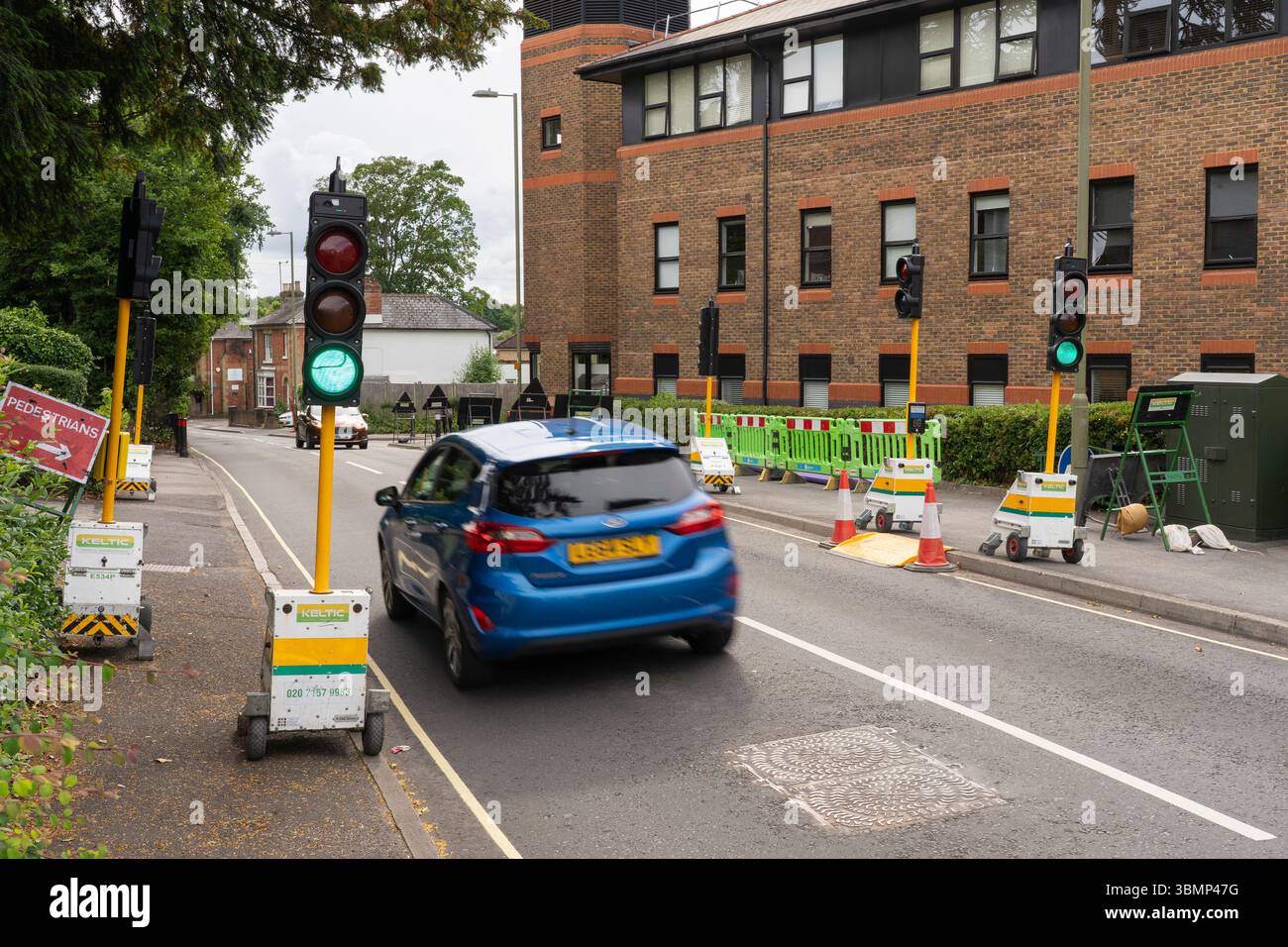 Car passing temporary pedestrian crossing with ramp and mobile traffic ...