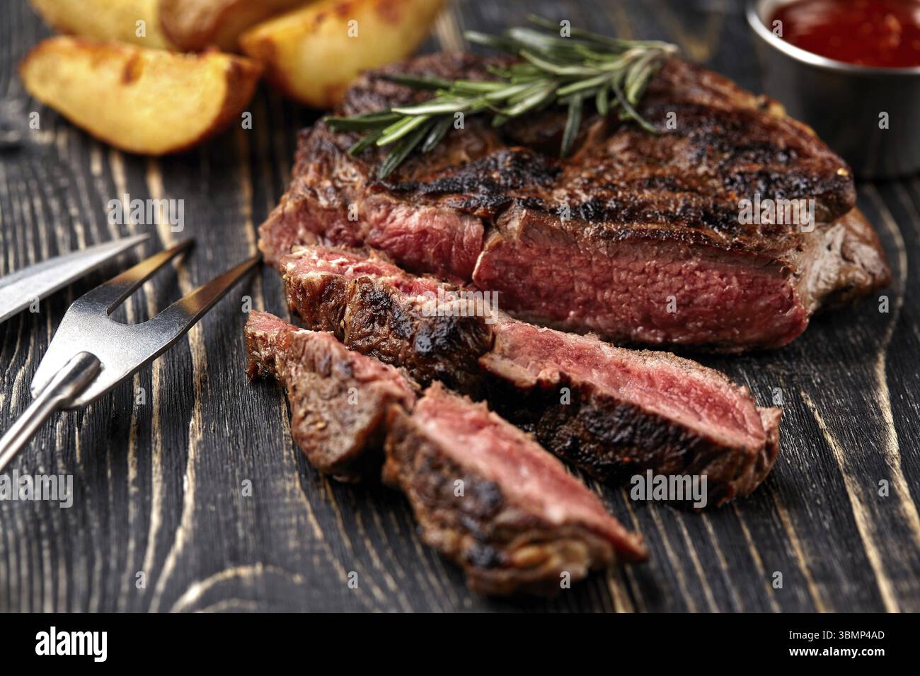 Juicy steak medium rare beef with spices on wooden board on table. dry ...